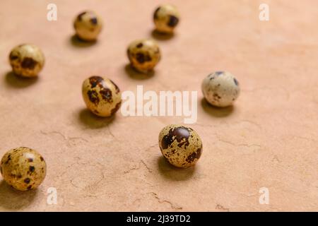 Fresh quail eggs on beige background Stock Photo - Alamy