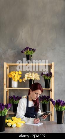 Businesswoman arranging customer orders in home decor store Stock Photo ...