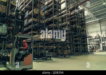 Interior of a modern warehouse with forklifts. Pallet stacker truck ...