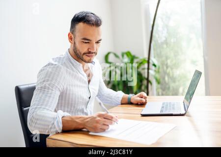 Portrait young mexican attractive businessman working at modern home ...