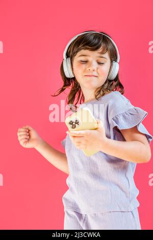 Adorable girl listening to music and dancing at home Stock Photo - Alamy