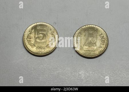 closeup of vintage 5 or five rupee gold coins of india arranged in a ...