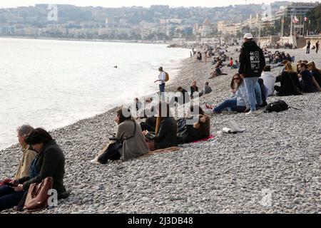 People seen sitting on the gravel beach on Plage du Centenaire on the ...