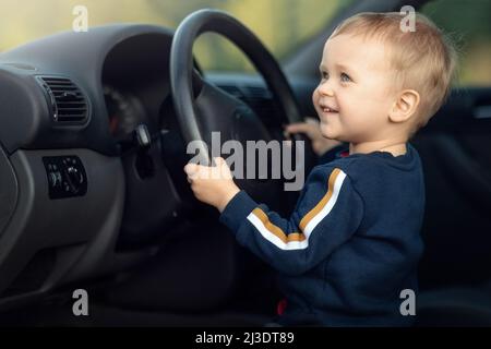 Little Driver. Cute little boy pretending to drive. Kid in car with his ...