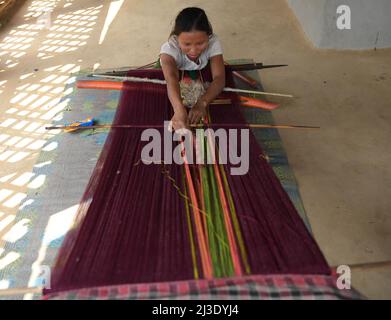 A tribal woman weaving "Rignawi", a traditional cloth used by the ...