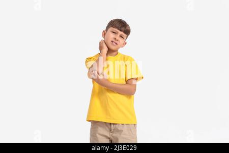 Little boy scratching himself on color background Stock Photo - Alamy