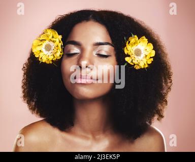 Happiness blooms from within. Shot of a beautiful young woman relaxing ...