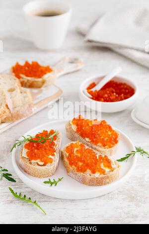 natural red salmon caviar with baguette and butter, making sandwiches ...