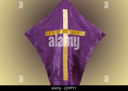 Holy Week. Cross covered with purple fabric in the period of lent ...