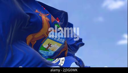 The US state flag of Michigan waving in the wind Stock Photo - Alamy