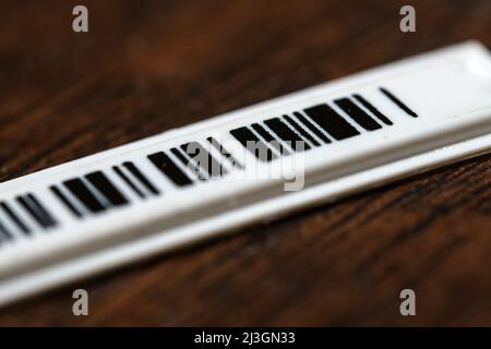 Tiny plastic security anti-theft barcode sticker with chip Stock Photo ...
