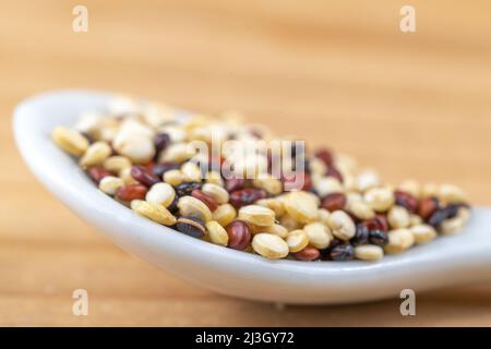 Macro of tri-colour quinoa grains in wood background Stock Photo - Alamy