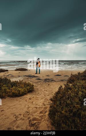 Epic standing man against bad weather and black clouds in background at ...