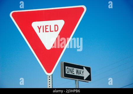 Yield and one way signs on freeway highway for drivers to see at ...