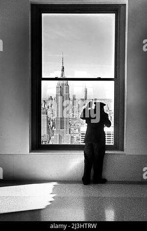 People sit in Rockefeller Center, Manhattan, New York City. (Photo by ...