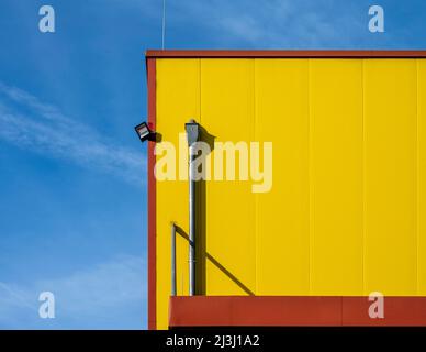 yellow warehouse, blue sky, spotlight Stock Photo - Alamy