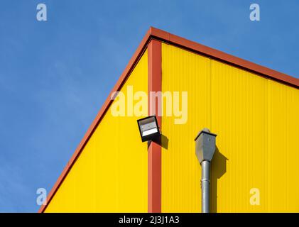 yellow warehouse, blue sky, spotlight Stock Photo - Alamy