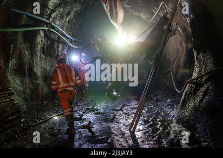 Mining operator on mining machine, underground mine mesh Stock Photo ...