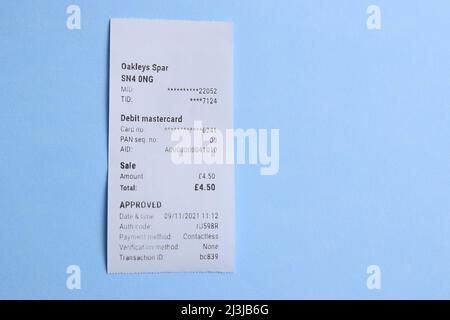 Coop till receipts in hand Stock Photo - Alamy