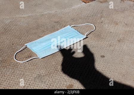 Shadow hand grabs mask Stock Photo - Alamy