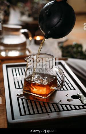 Traditional Chinese tea ceremony Gun Fu Cha and pouring oolong from a ...