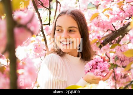 happy teen girl at sakura flower bloom in spring Stock Photo - Alamy