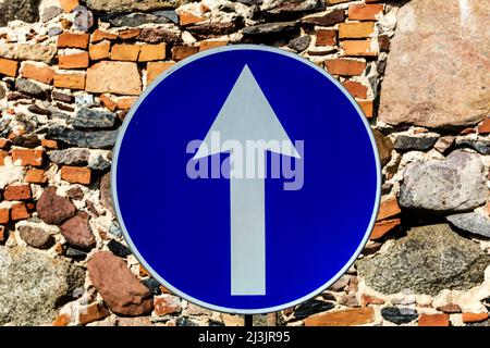Blue round sign with white arrow pointing up or forward, meaning right ...