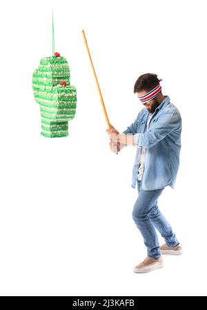 Handsome man breaking Mexican pinata on color background Stock Photo ...