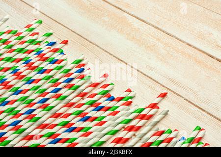 Stylish straws for drinks on light wooden background Stock Photo - Alamy