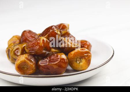 Kurma Sukkari or Sukkari Dates on marble white background. Breakfasting ...
