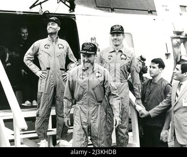 The crew of the Apollo 13 mission step aboard the U.S.S. Iwo Jima ...