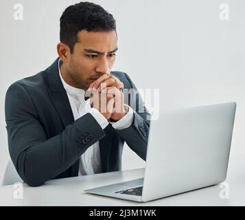 Frozen young man working with laptop in office during blackout Stock ...