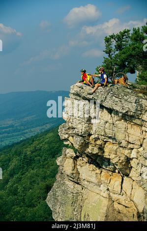 Cyclists relax on a rock outcropping overlooking Germany Valley ...
