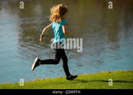 Kid runners run on lawn in park. Child running outdoor. Healthy sport ...