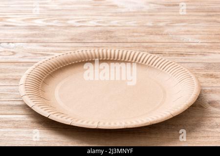 Perspective view of eco paper plate on wooden background. Empty space ...