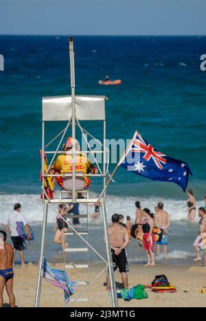Surf lifesaver overseeing beach, watching for danger and people in ...