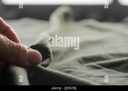 man touching green cotton clothes closeup, wide photo Stock Photo - Alamy