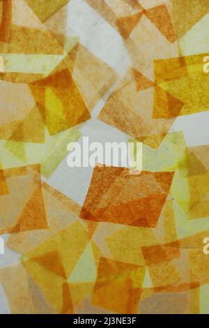 Craft tissue paper glued to a window as an abstract orange translucent ...