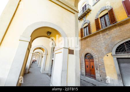 Beautiful arcade near famous Ponte Vecchio on Arno river in Florence ...