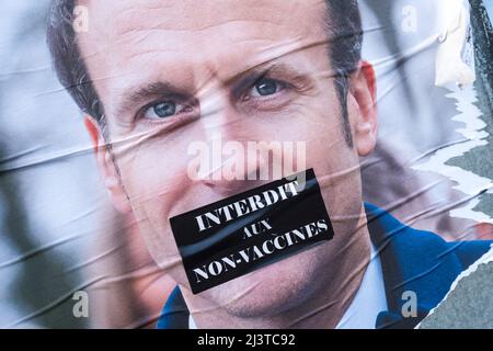 Poster of Emmanuel Macron with a sticker on the mouth saying "Forbidden ...