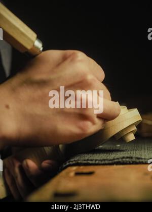 artisan sculpting a violin scroll - luthier at work concept Stock Photo ...