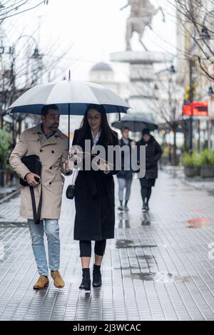 Four amazing and beautiful business people are walking together and ...