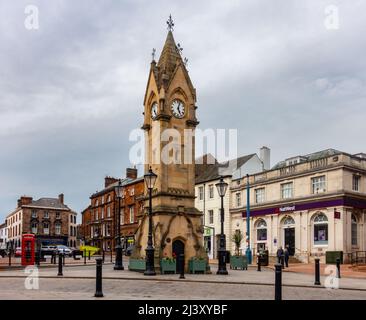 Shops in Market Square in Penrith town centre in Cumbria, ENgland, UK ...