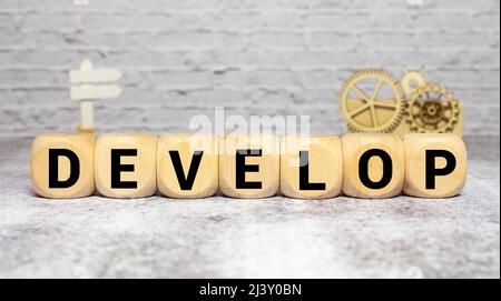 Develop word written on wood block. Develop text on cement table for ...