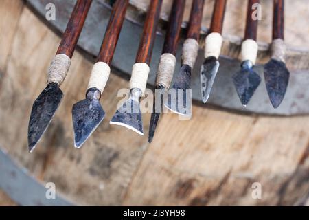 Different types of arrowheads made of iron on wooden background Stock ...