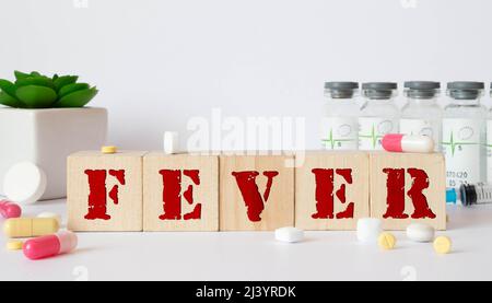 FEVER word made with building blocks. Wooden block with words Fever ...