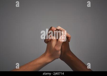 Inside, were the same. Studio shot of unidentifiable hands holding on ...