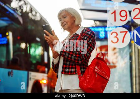Busy senior lady taking stroll through city Stock Photo - Alamy
