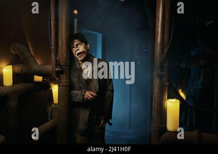 Zombie man in basement with pipes portrait Stock Photo - Alamy