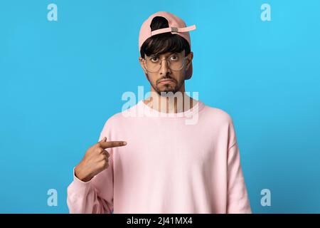 Man with puzzled face pointing at himself, person with confused gesture ...